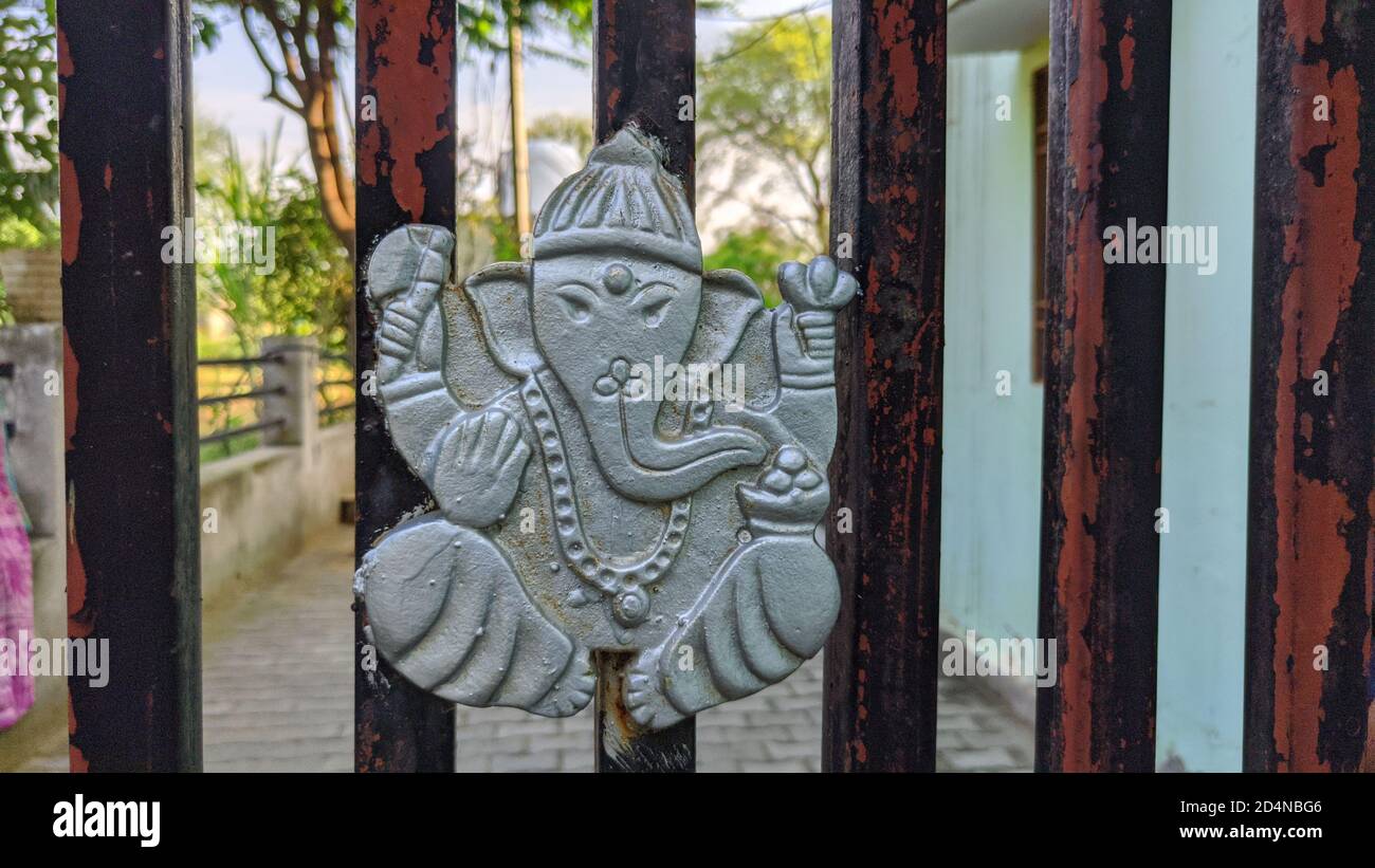 An iron statue of lord Ganesha hanging above a main entrance gate Stock ...