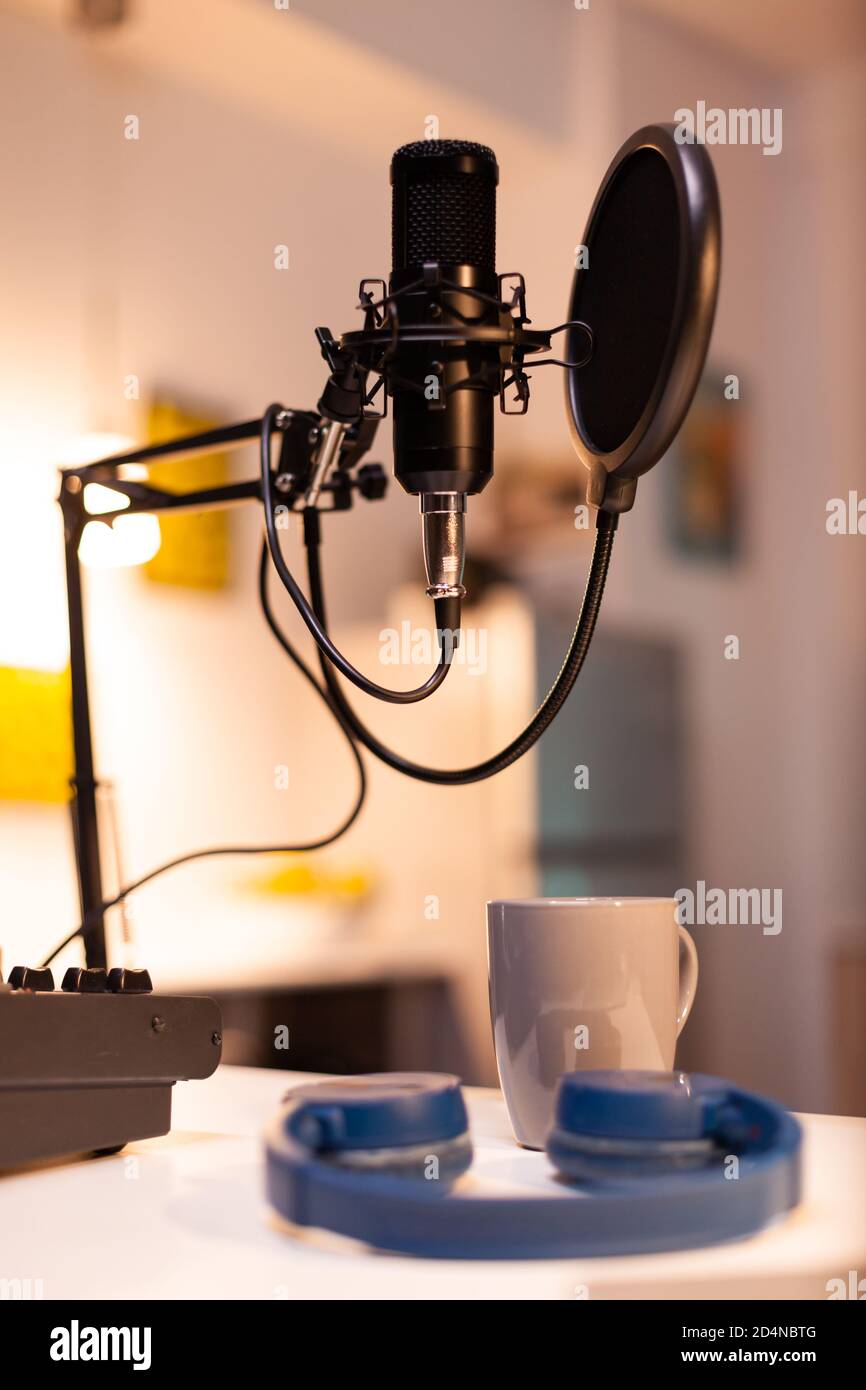 Zooming on professional microphone in vlogger home studio and neon ...