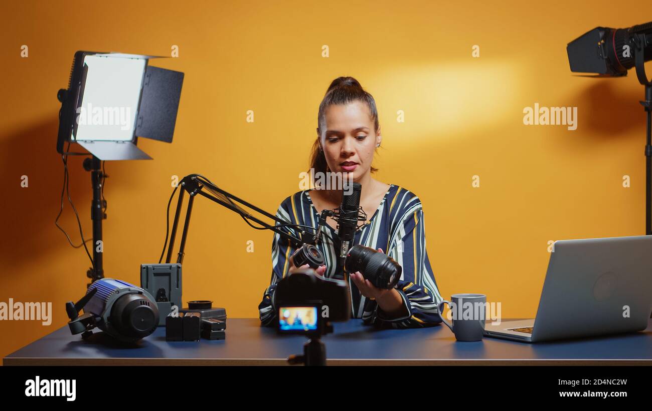 Content creator making a camera lens comparison in her professional ...