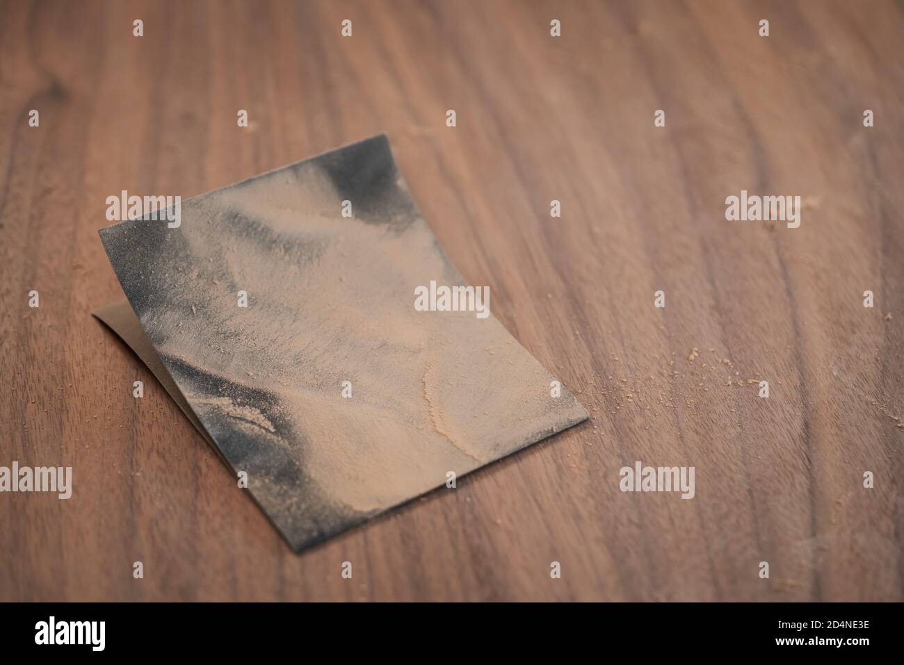 Piece of sandpaper on black walnut table, with copy space Stock Photo ...