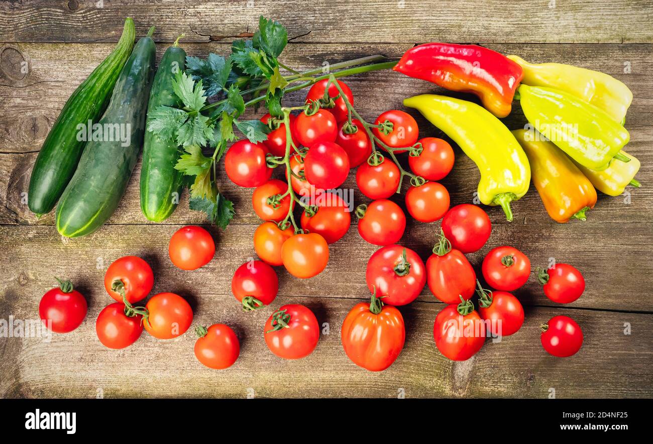 Harvest of fresh ripe vegetables on wooden table - pepper, tomato ...