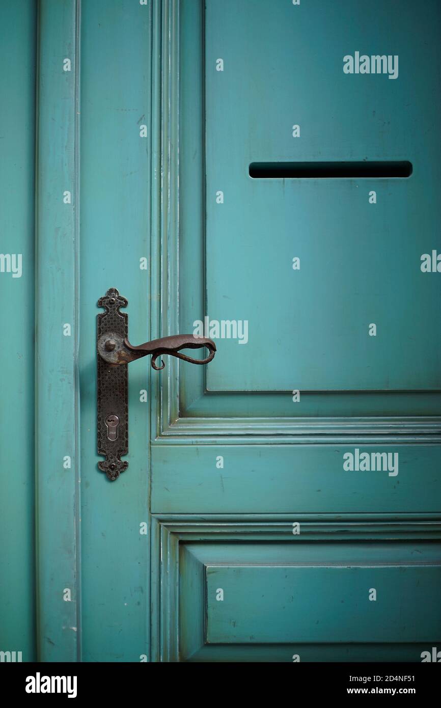 Vertical shot of a green door with an old handle and letter hole Stock ...