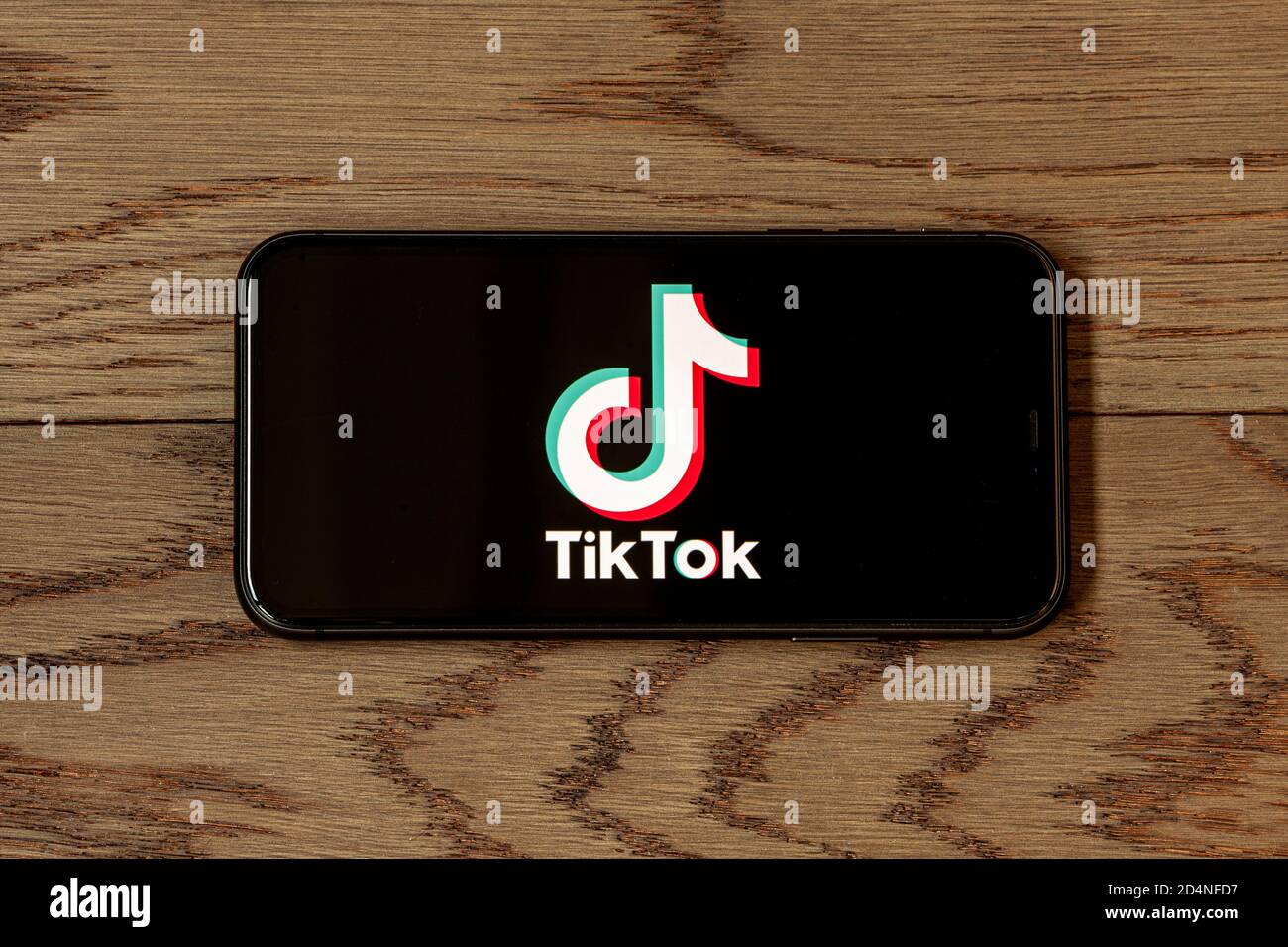 TikTok application icon on Apple iPhone 11 screen close-up. Hand ...