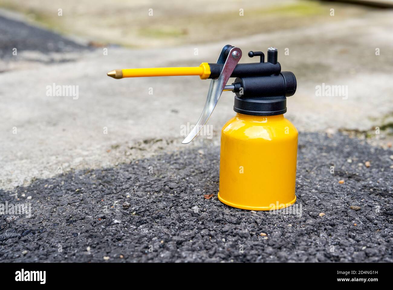 Closeup of a yellow motor oil spray can Stock Photo - Alamy