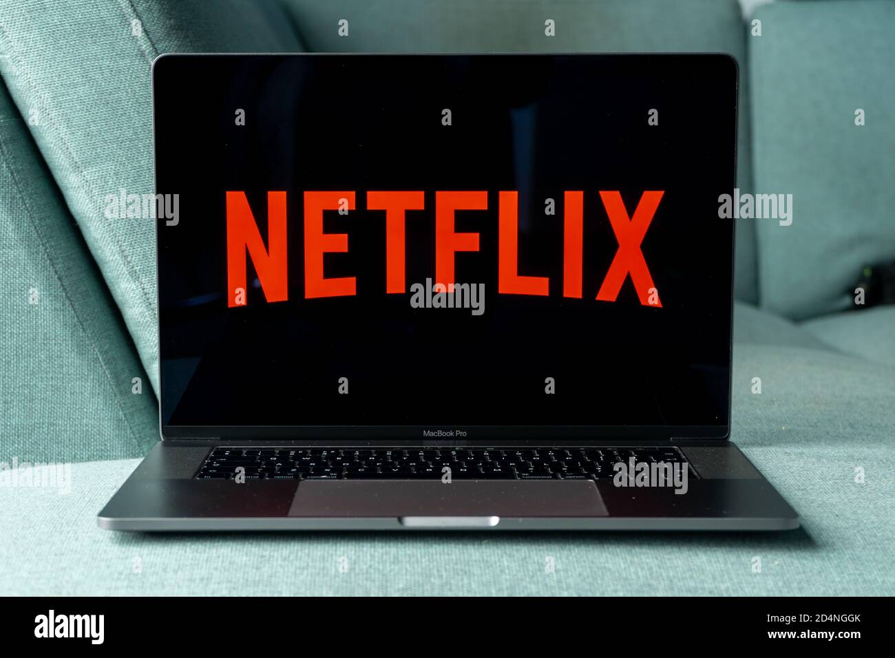 Table with Netflix logo on Apple MacBook Pro. Netflix is a global ...