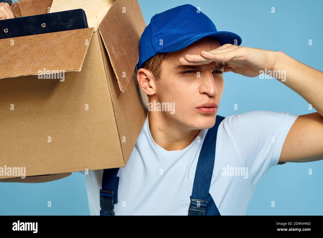 working man in uniform box with tools loader delivery blue background ...