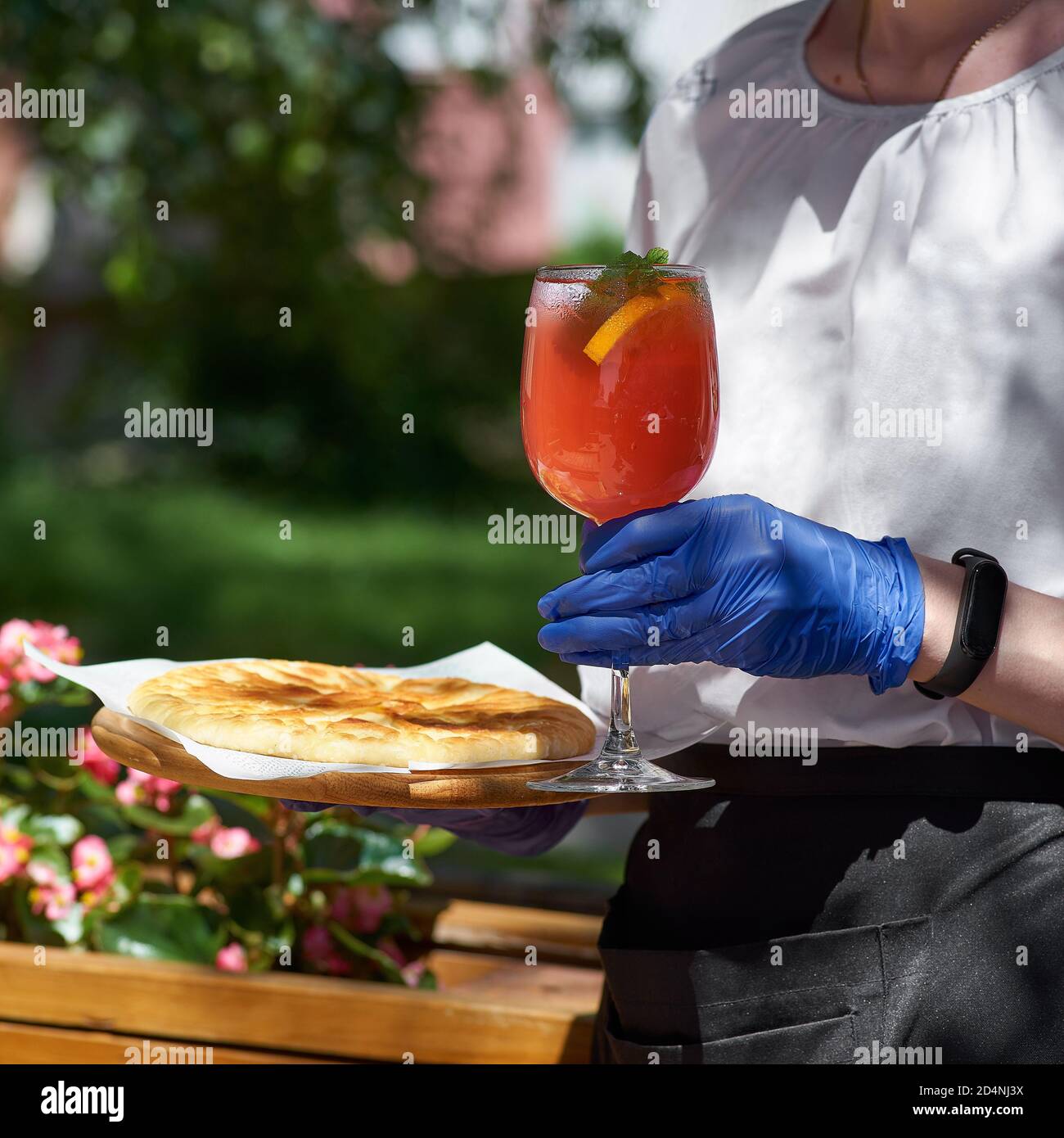 Vertuta with cheese and a glass of red lemonade in the hands of a ...