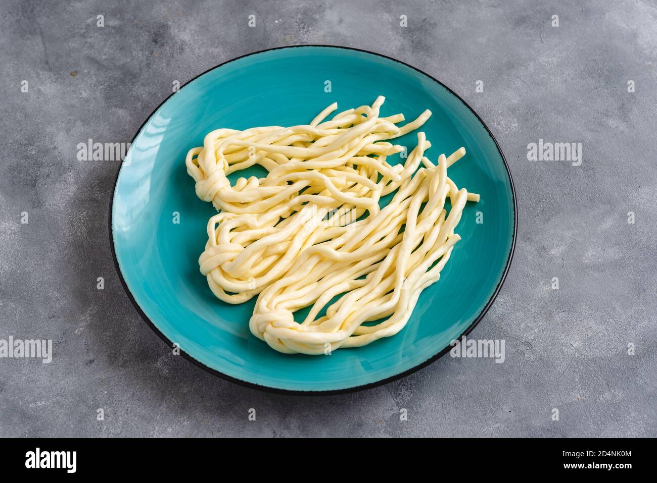 Braided cheese pigtail. Traditional polish salty string cheese Stock ...