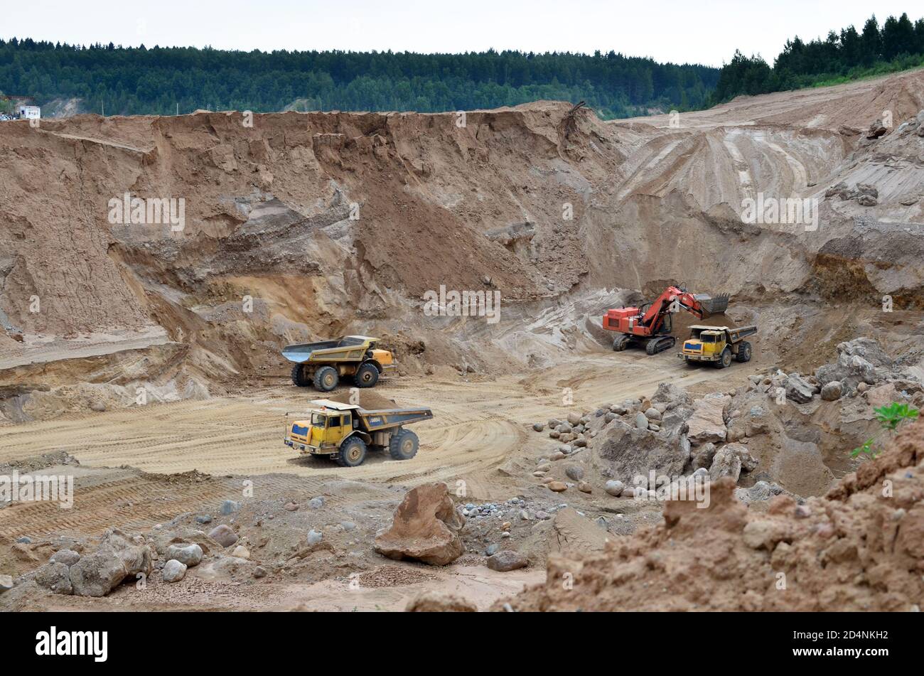 Excavator developing the sand on the opencast and loading it to the ...