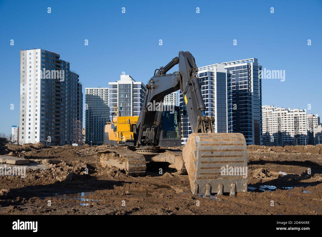 Excavator during earthmoving at construction site on blue sky ...