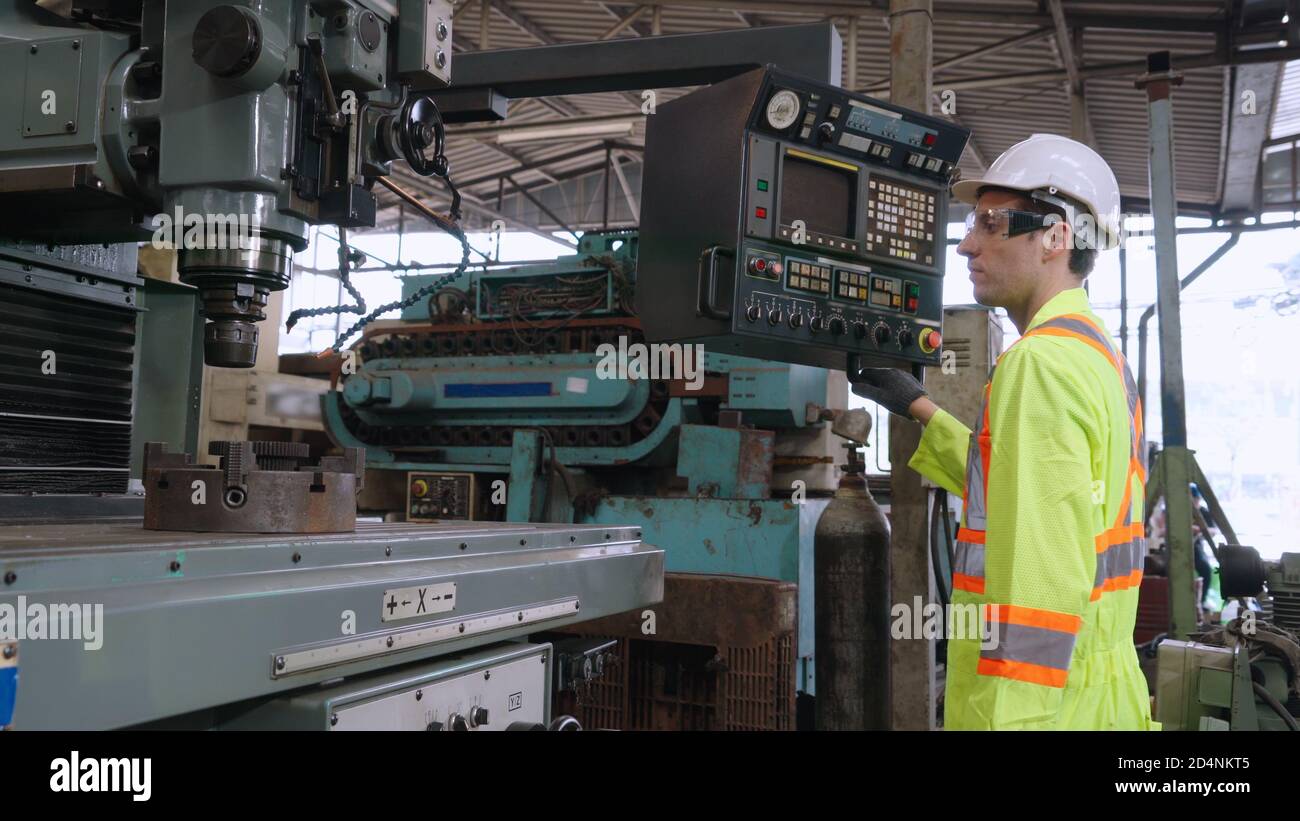 Smart factory worker using machine in factory workshop . Industry and ...
