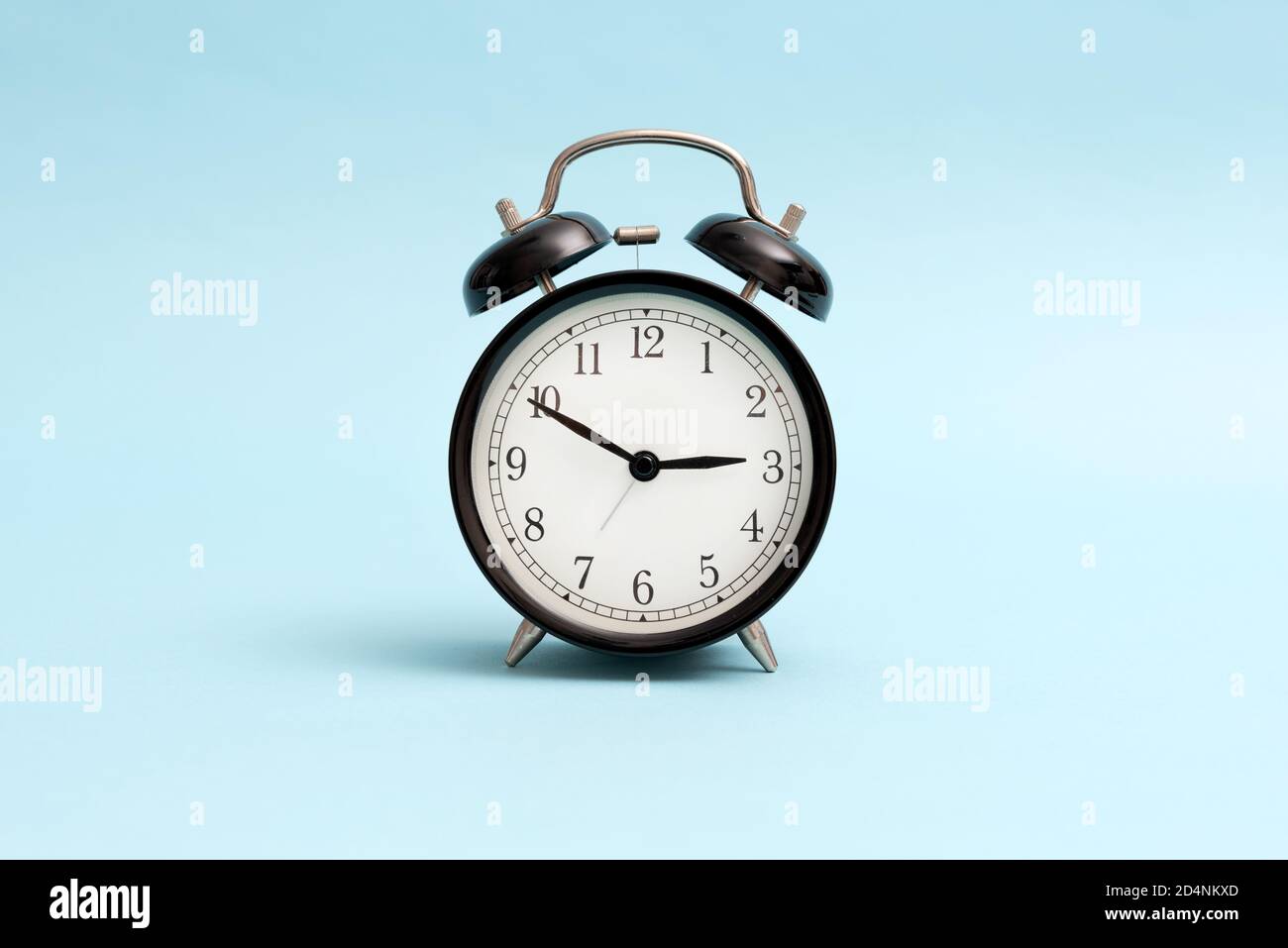 Analog clock front view, isolated on blue background Stock Photo - Alamy
