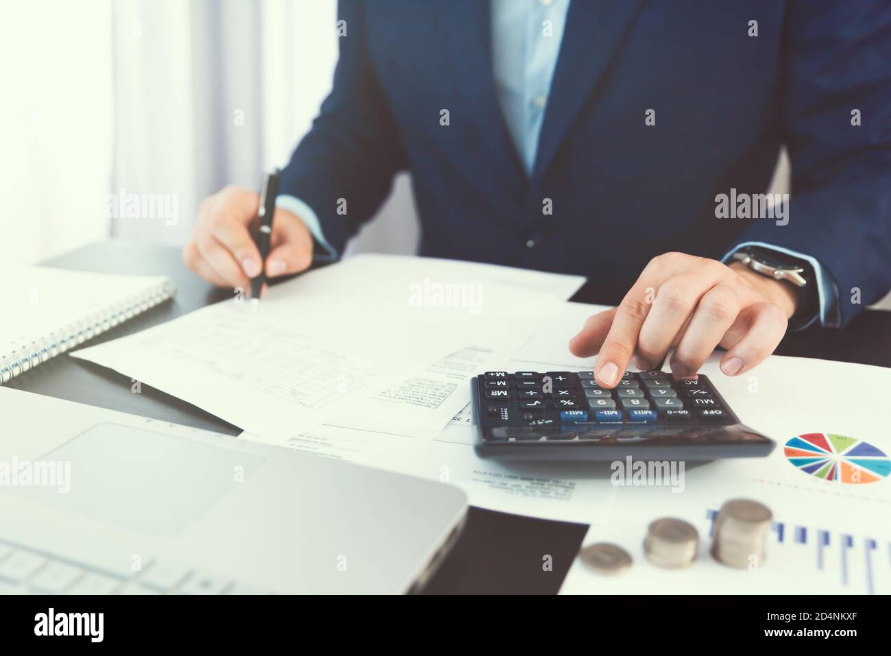 Accountant at work in the office. Man calculates income and expenses ...