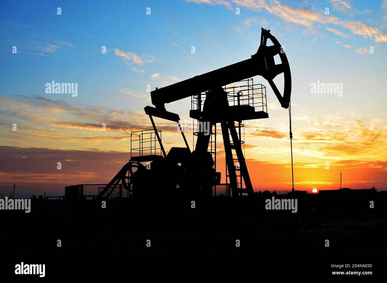 Oil drilling derricks at desert oilfield for fossil fuels output and ...