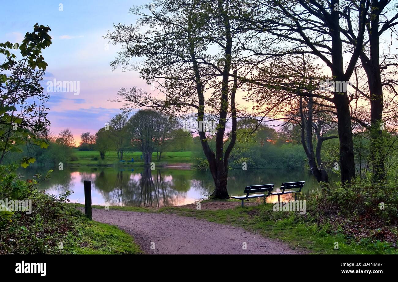 Beautiful sunset landscape at a lake with a reflective water surface ...