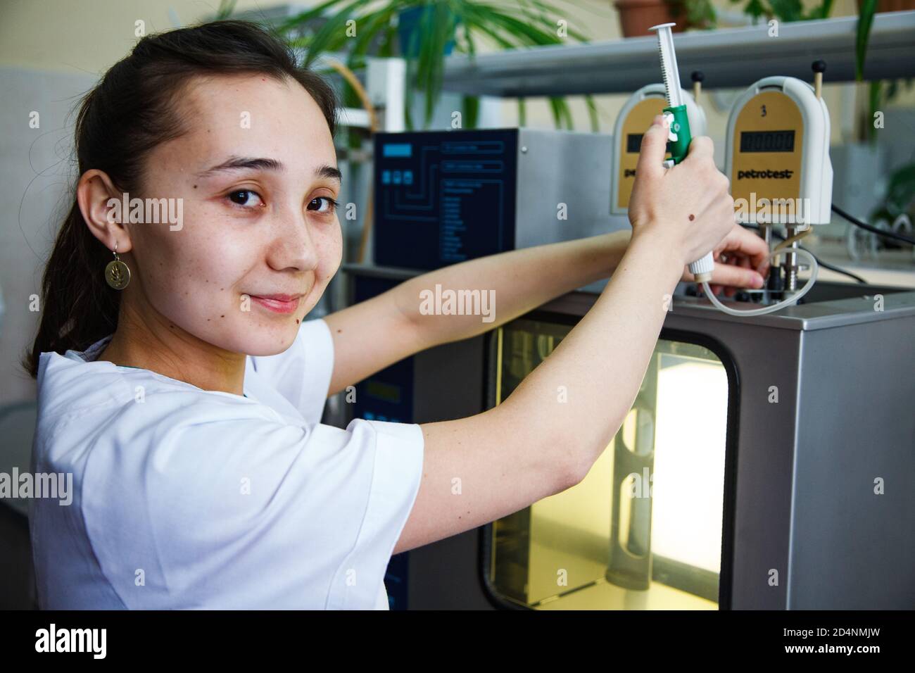 Motor oil modern production plant. Chemical lab. Young Asian woman ...