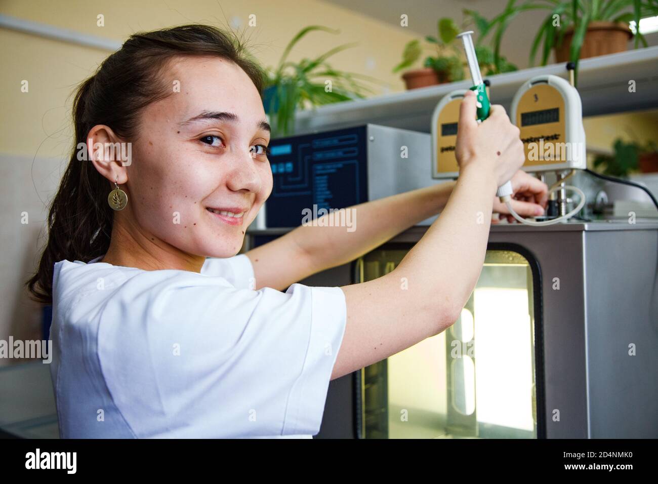 Motor oil modern production plant. Chemical lab. Young Asian woman ...