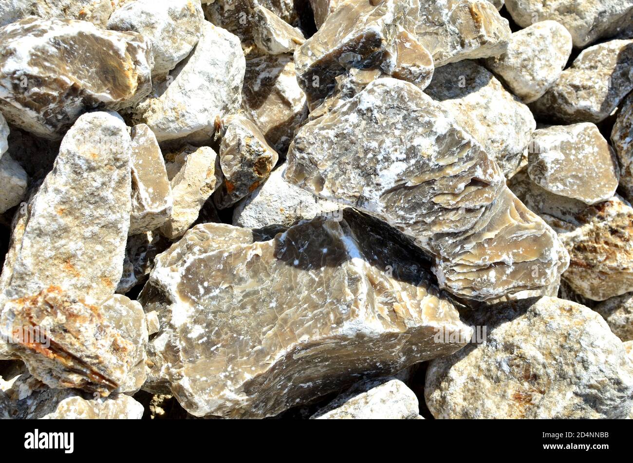 Natural gray gypsum stone. Close up image of stones with black and ...