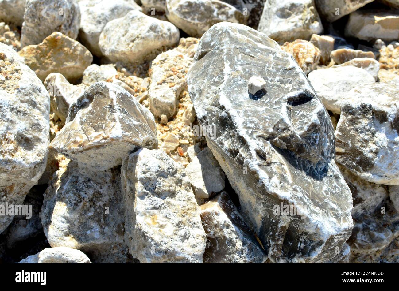 Natural gray gypsum stone. Close up image of stones with black and ...