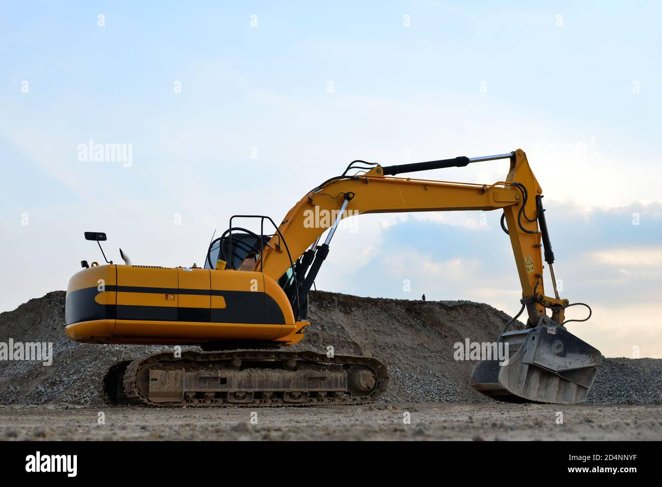 Excavator with crusher bucket for crushing concrete. Construction waste ...