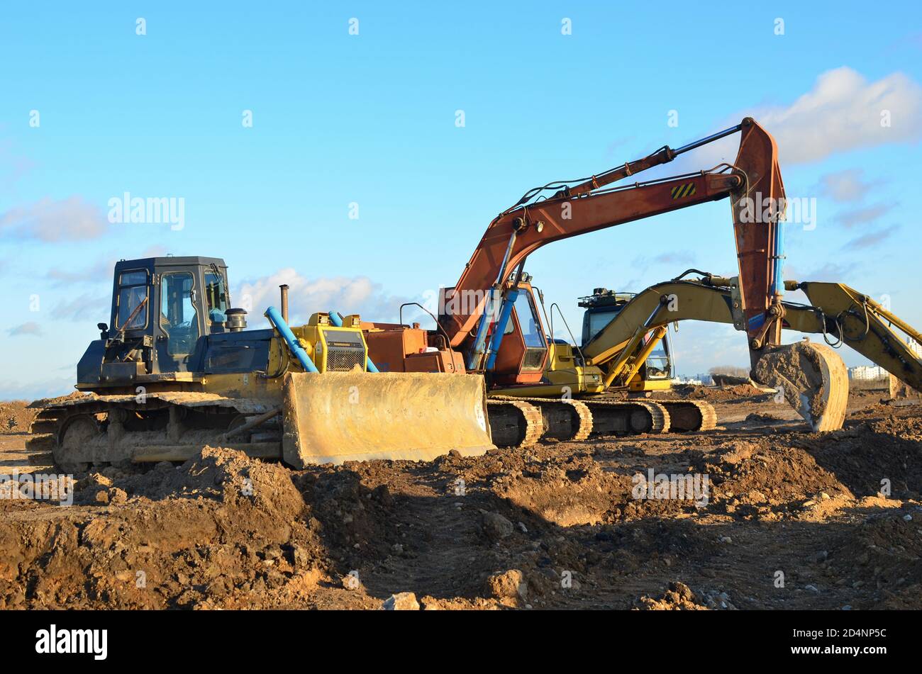 Excavators and dozer digs ground at a construction site for installing ...
