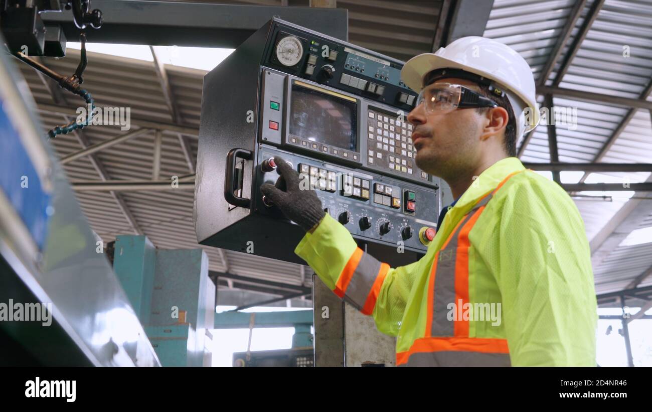 Smart factory worker using machine in factory workshop . Industry and ...