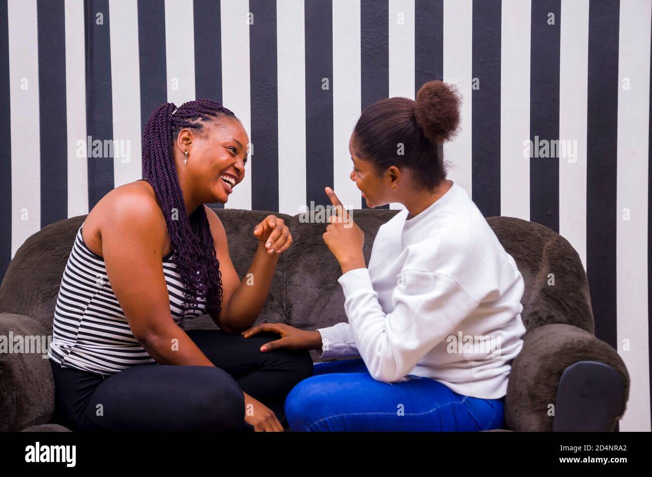 two pretty african ladies feeling overjoyed as they discuss Stock Photo ...
