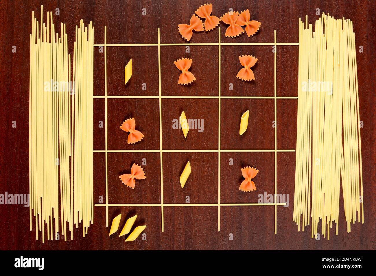 Italian pasta. Tic Tac Toe or Xs and Os game made from raw spaghetti ...