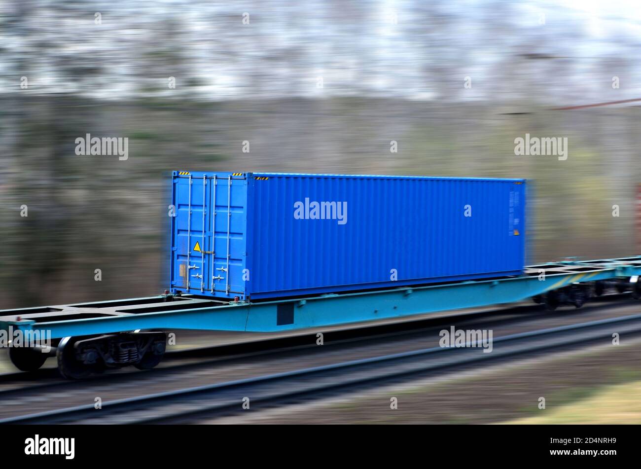 Freight train with cargo containers on railway with motion blur effect ...