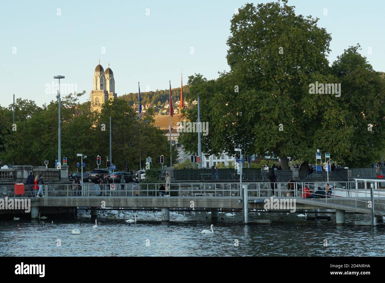 Lake Zurich pier on an early autumn weekend day with Grossmunster ...