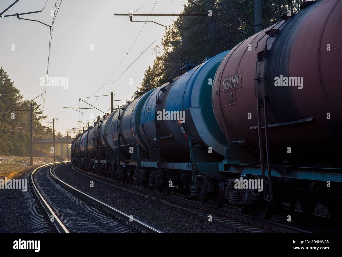 Freight train with petroleum tank cars on railroad. Rail cars carry oil ...
