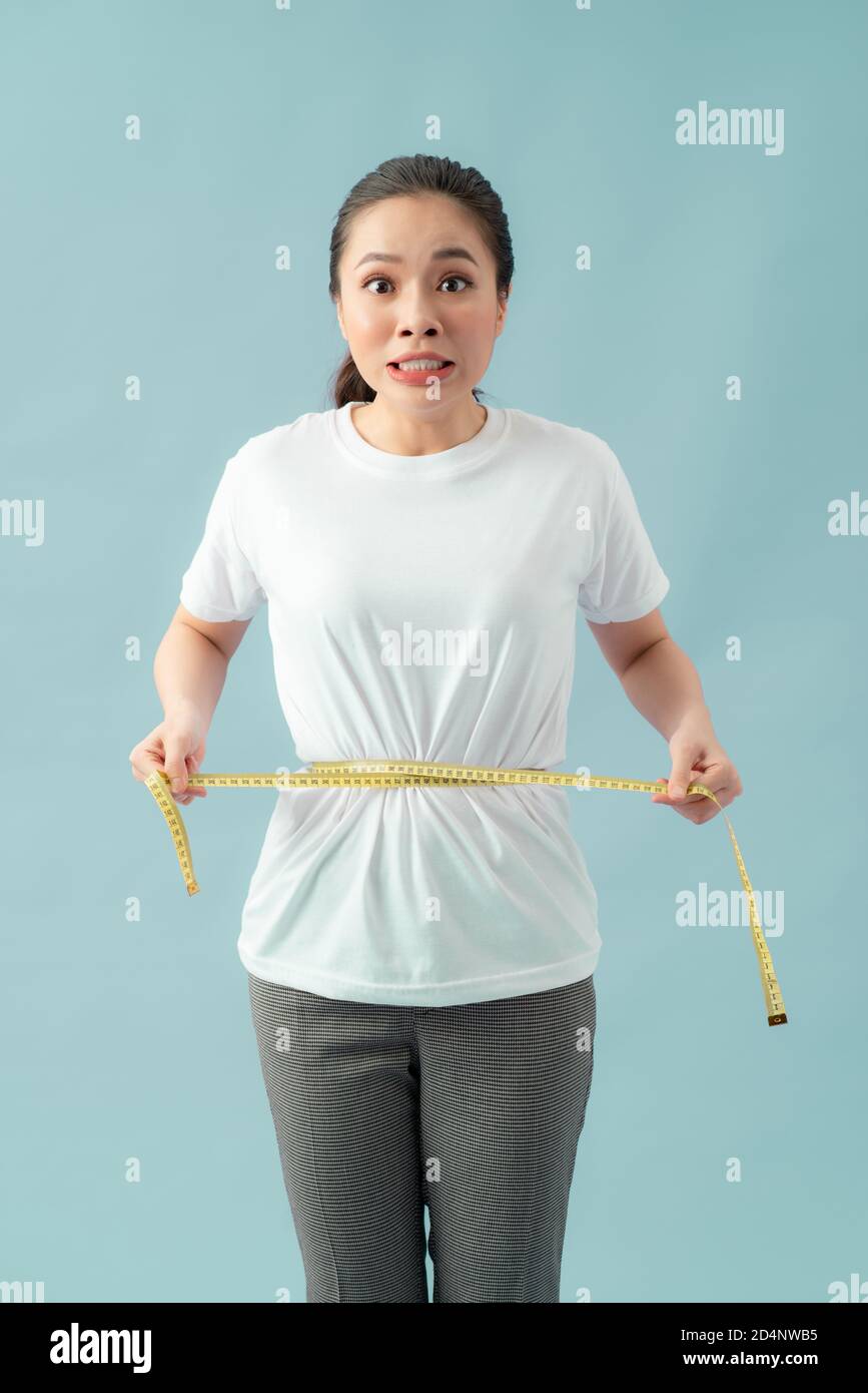 astonished slim woman measuring her waist Stock Photo - Alamy