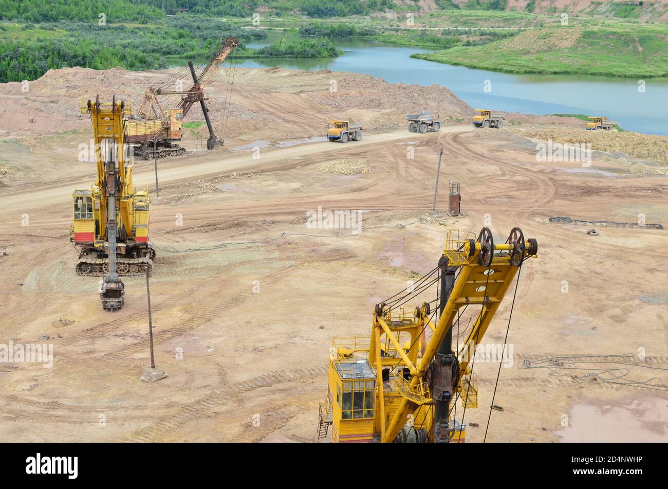 Huge excavators with electric shovel working in the quarry. Big dump ...