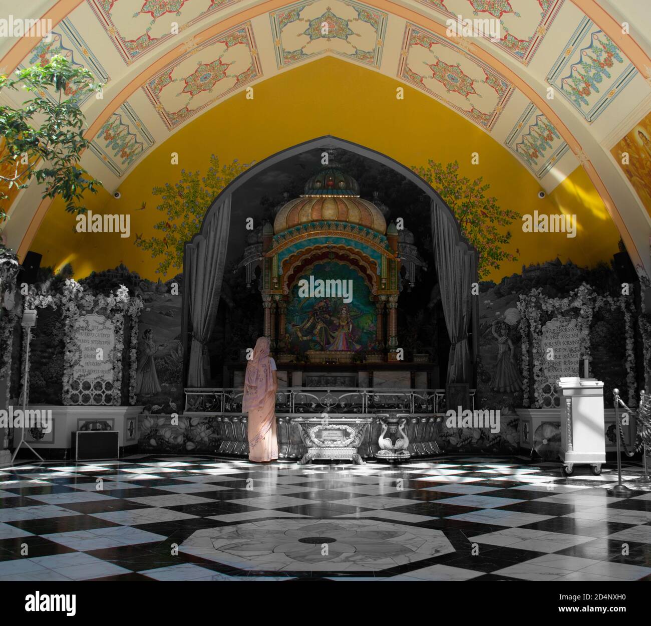 Woman praying in a robe in a Krishna Temple Stock Photo - Alamy