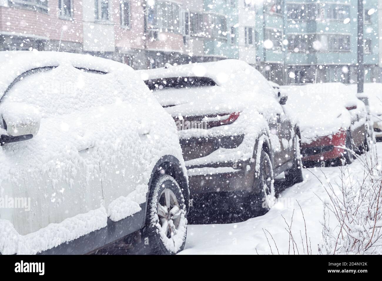Snowstorm, snow-covered street and cars. winter and christmas concept ...