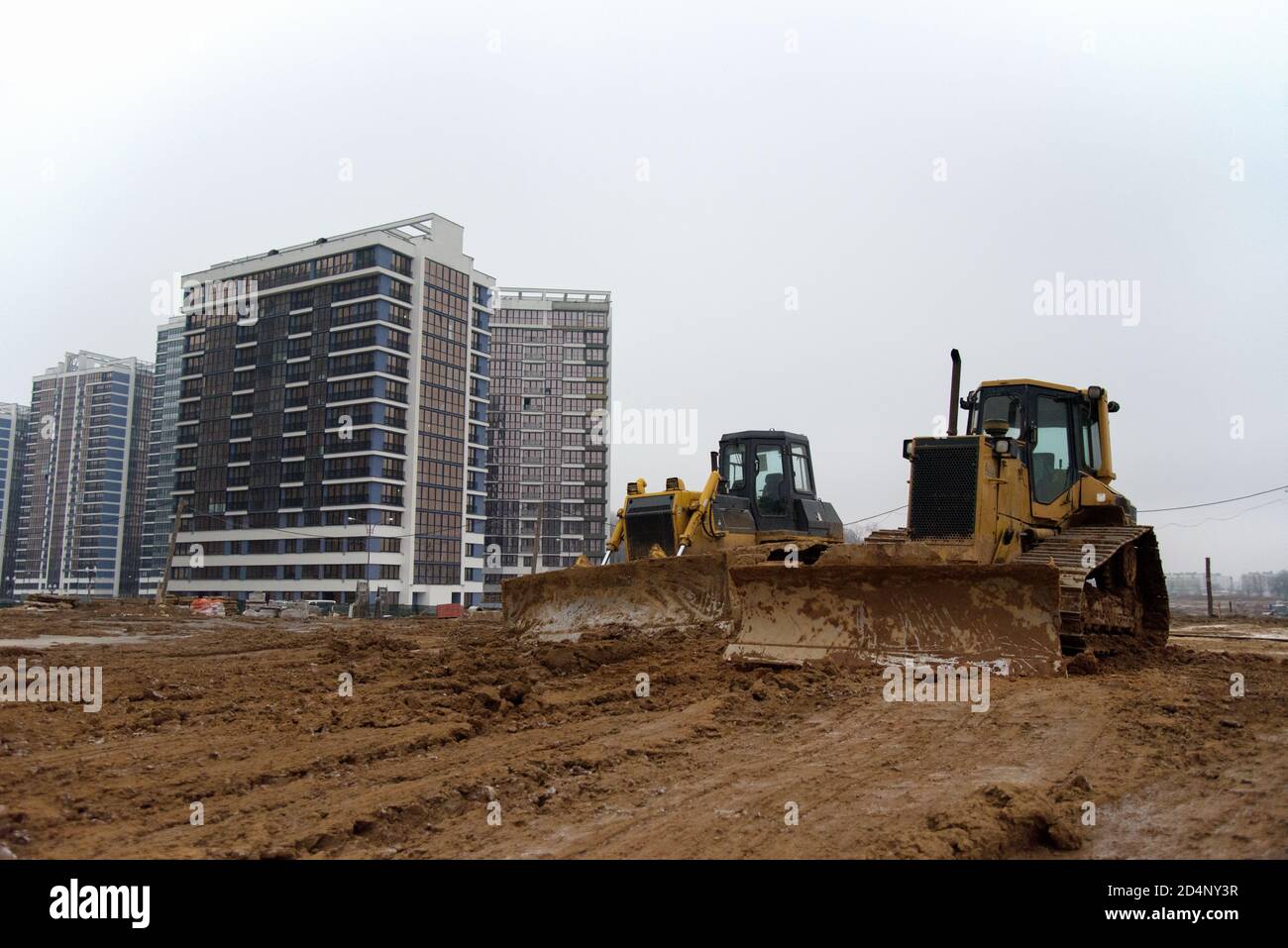 Group of dozers with buckets at construction site. Bulldozer during ...