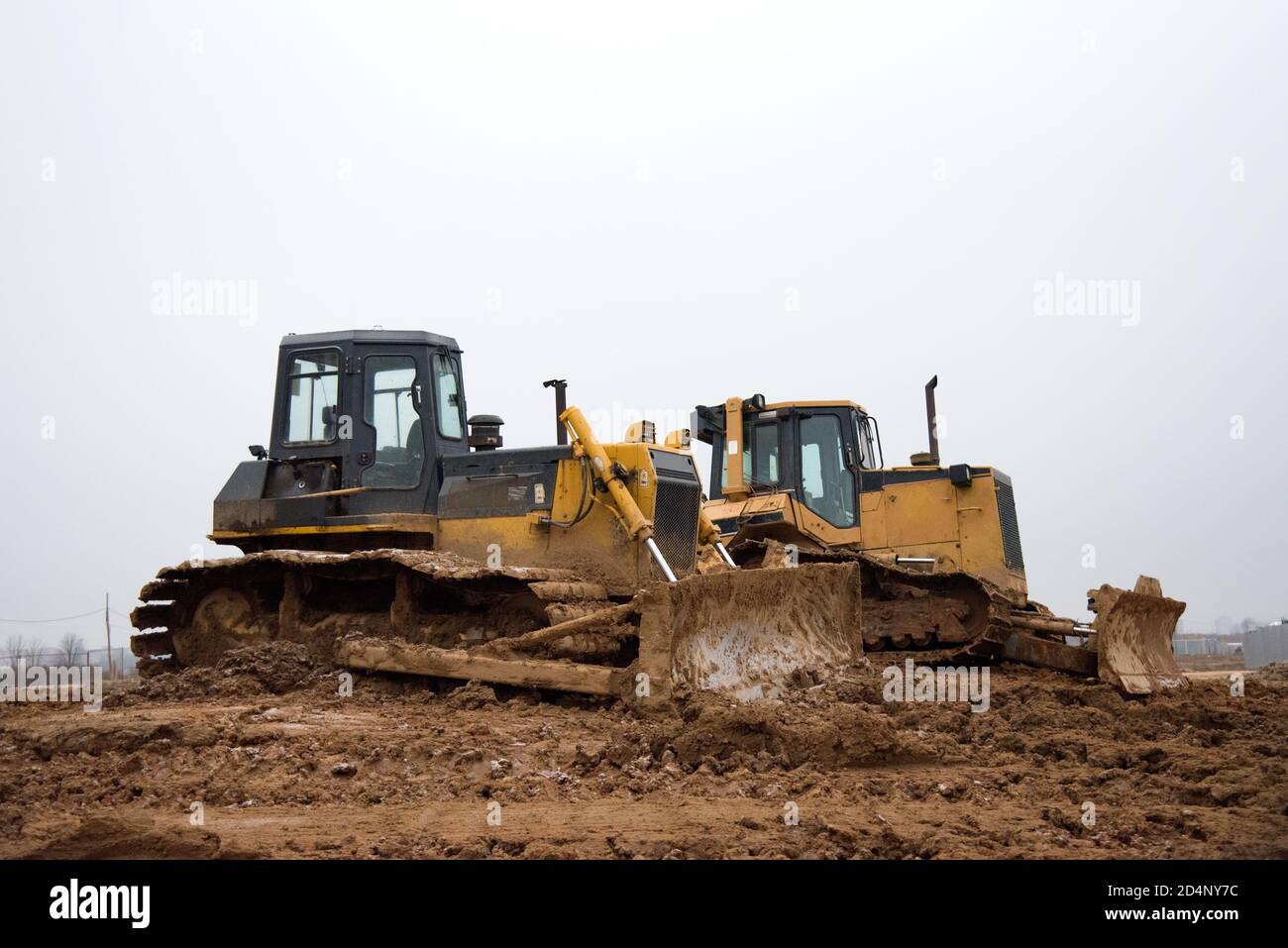Dozer with buckets at construction site. Bulldozer during land clearing ...