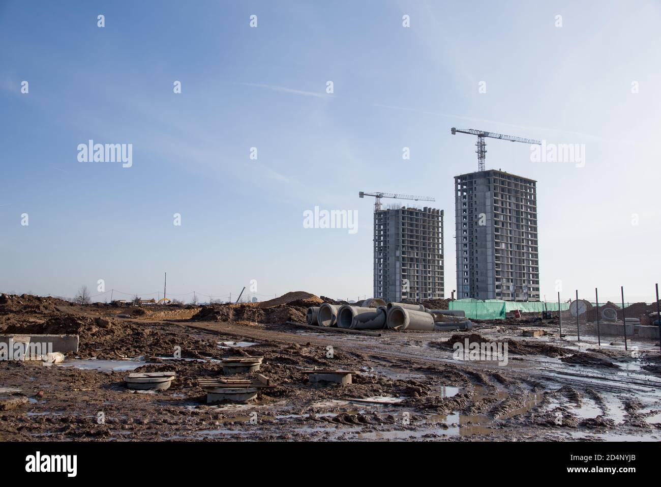 Tower cranes constructing a new residential build. Pouring concrete ...