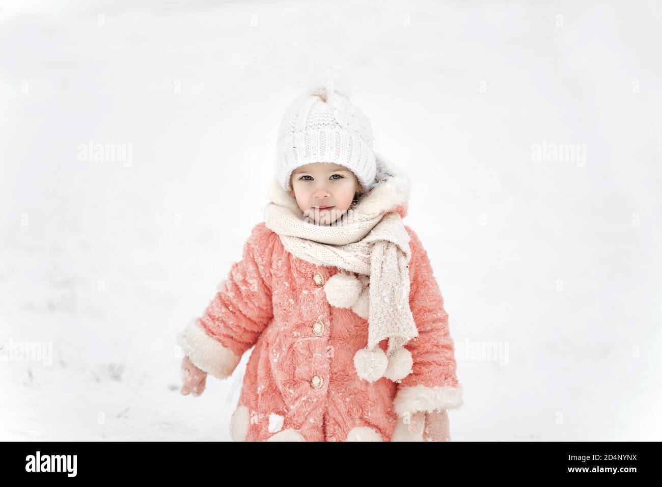 Happy baby girl rejoices in falling snow Stock Photo - Alamy