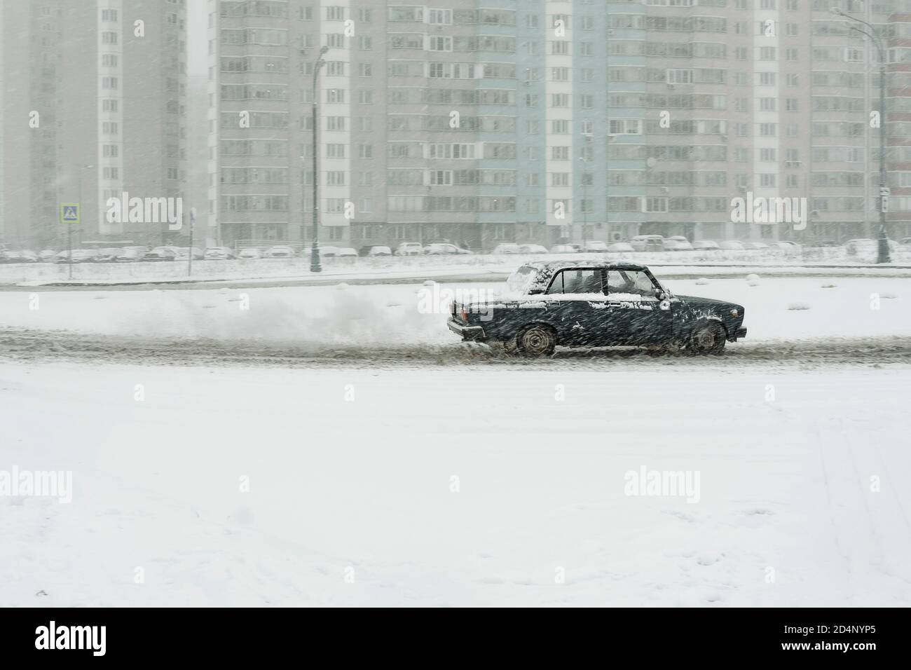 car skids on the road in the city in a strong snow storm Stock Photo ...