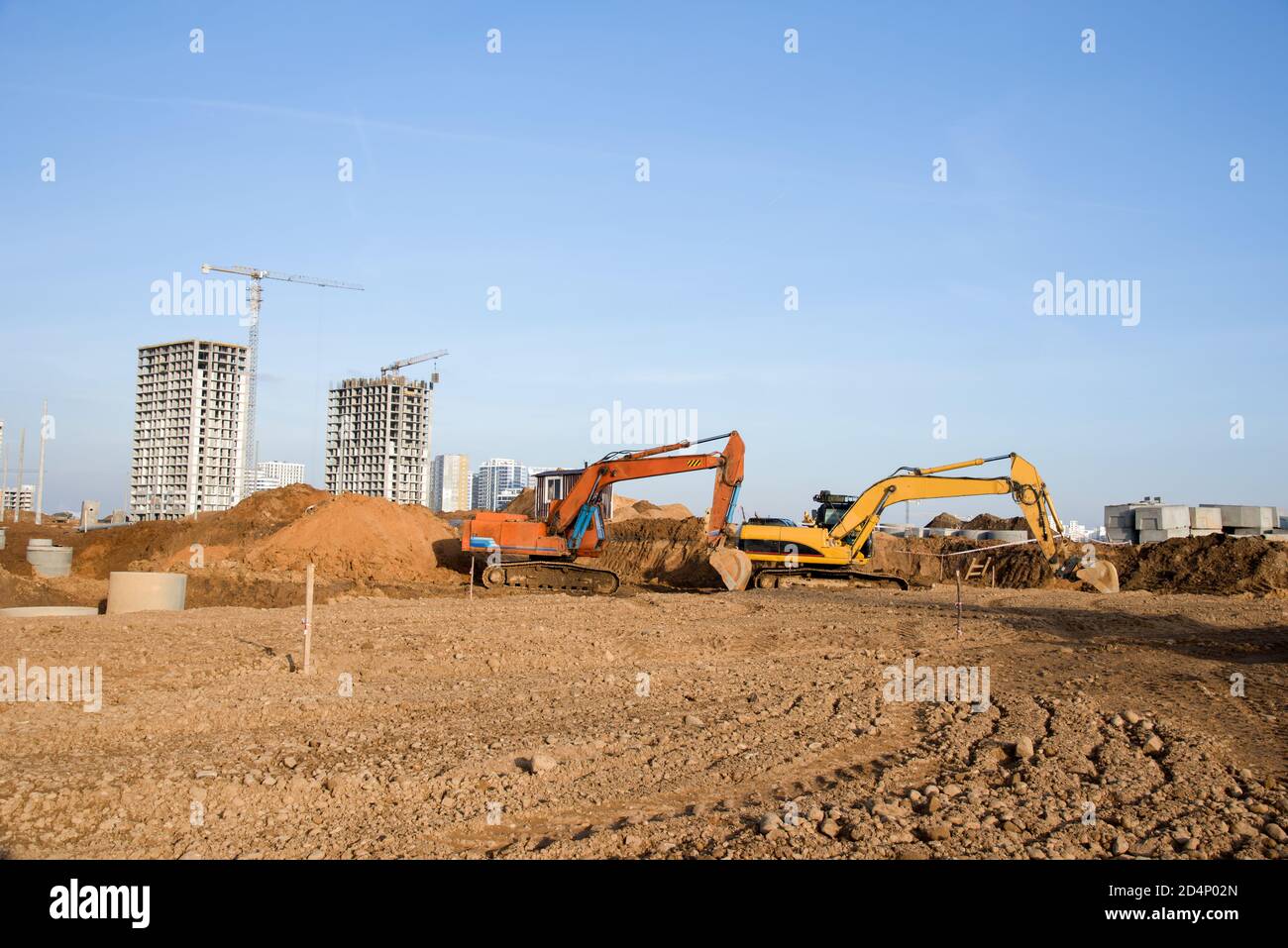 Group of the excavators for dig ground trenching at a construction site ...