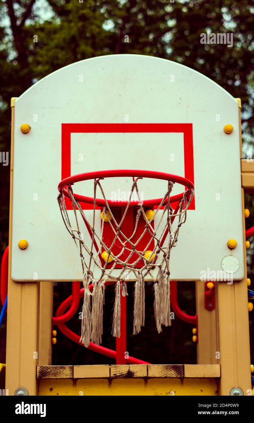 Vertical shot of basketball net and hoop attached to a backboard at a ...