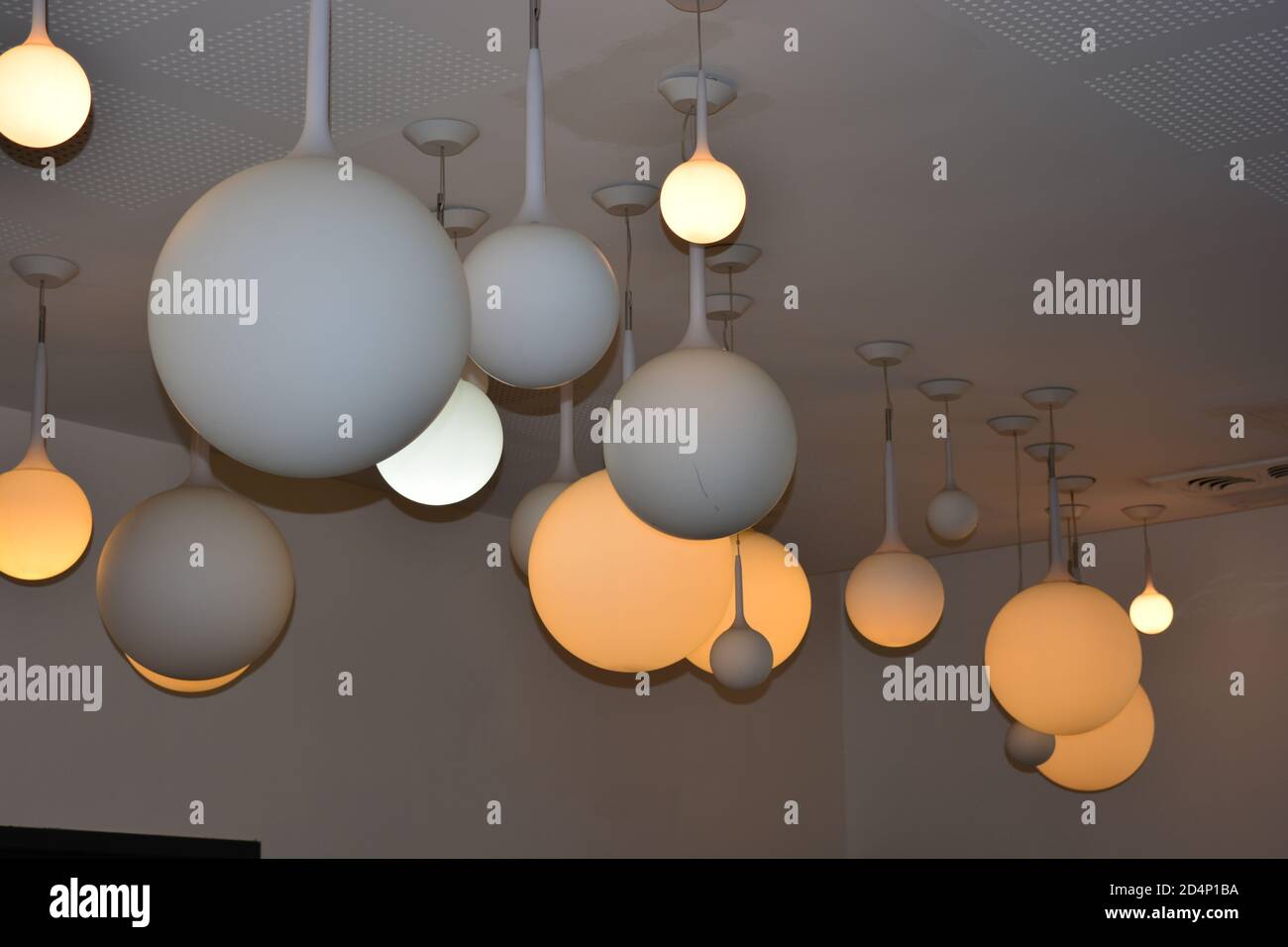 Low angle shot of hanging stylish lamp balls inside a building Stock ...