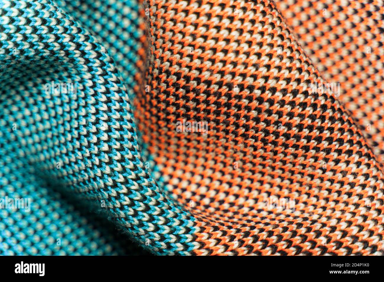 A pile of multi-colored synthetic knitted fabrics of different ...