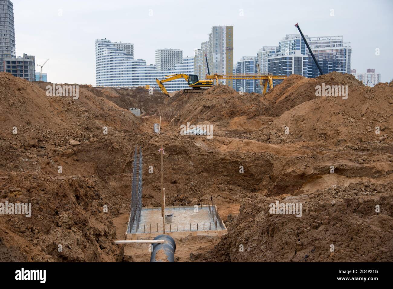 Excavator at construction site during laying sewer and main ...