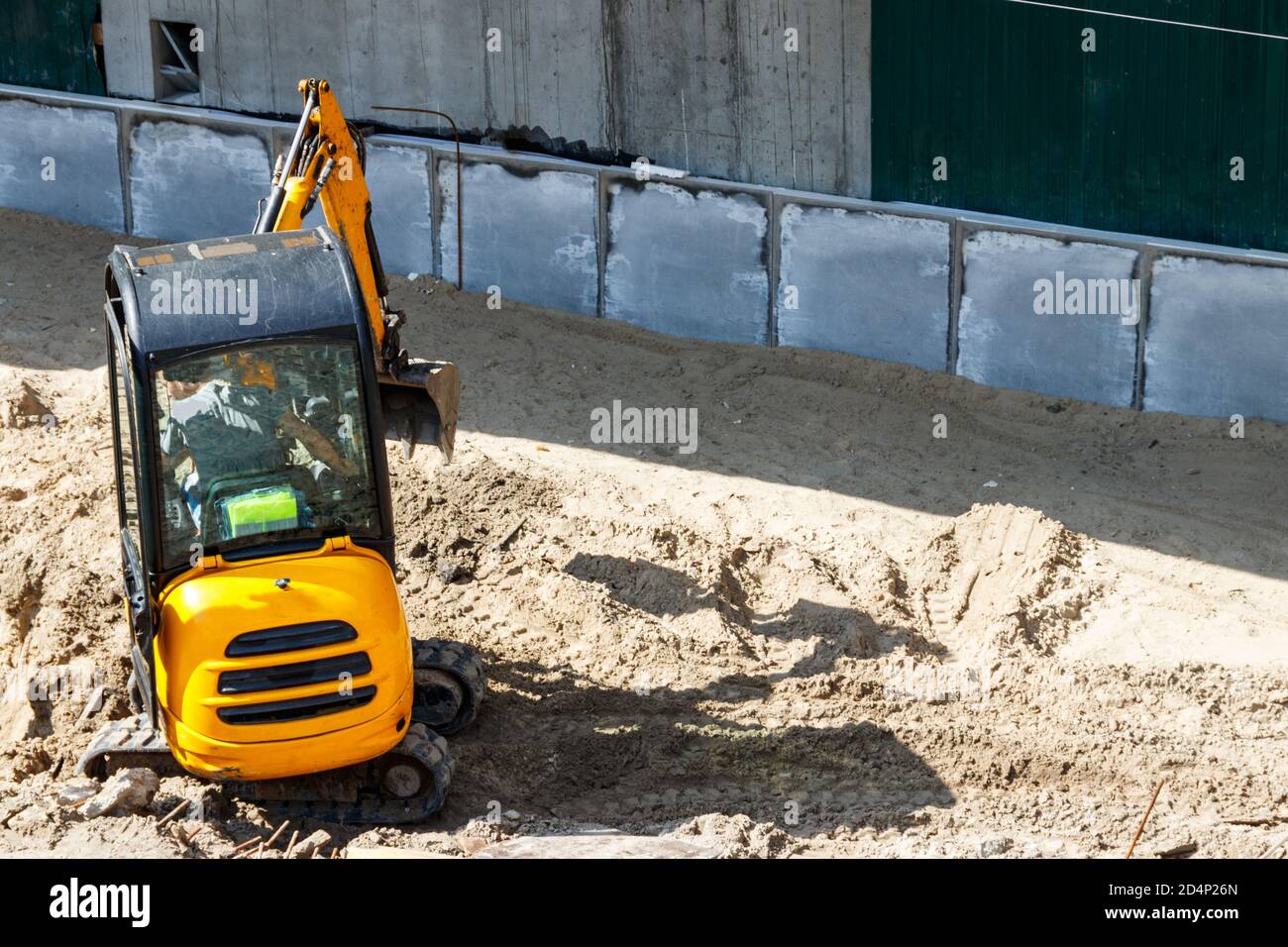 Mini excavator on construction site Stock Photo - Alamy