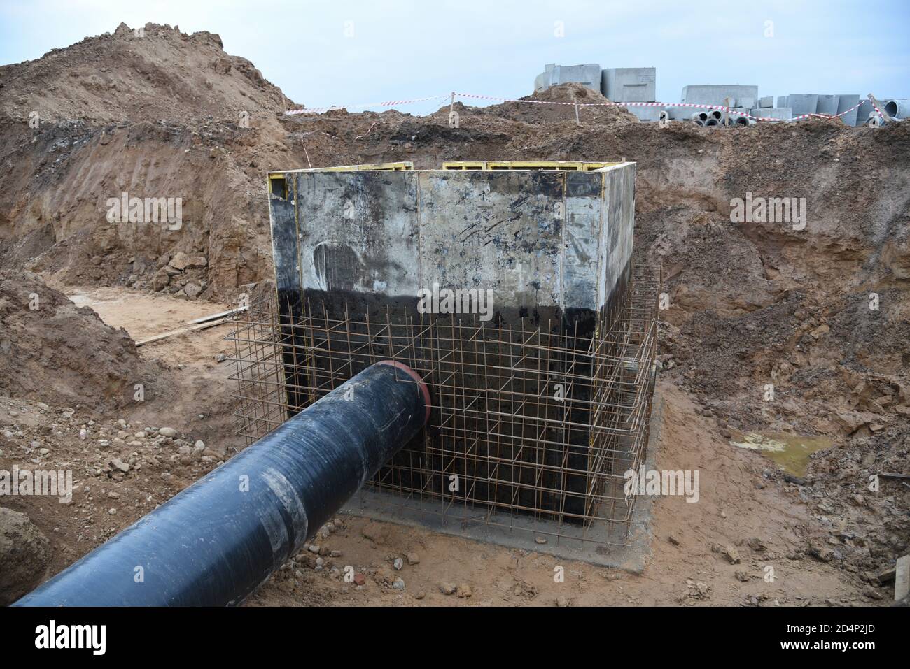 Laying of underground storm sewer pipes in ditch. Installation of water ...