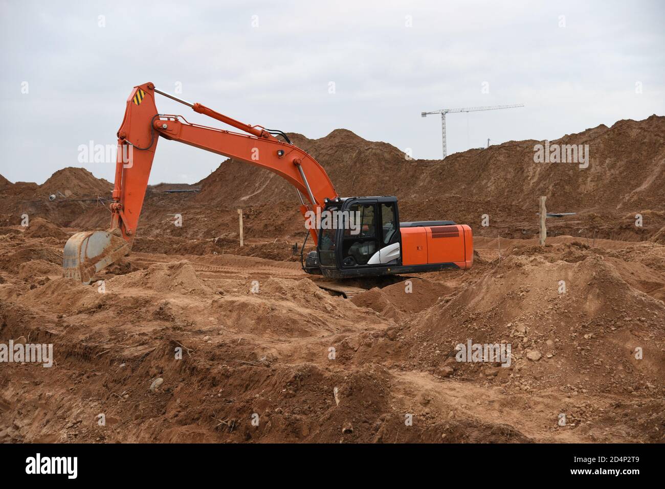 Track-type excavator during earthmoving at construction site. Backhoe ...