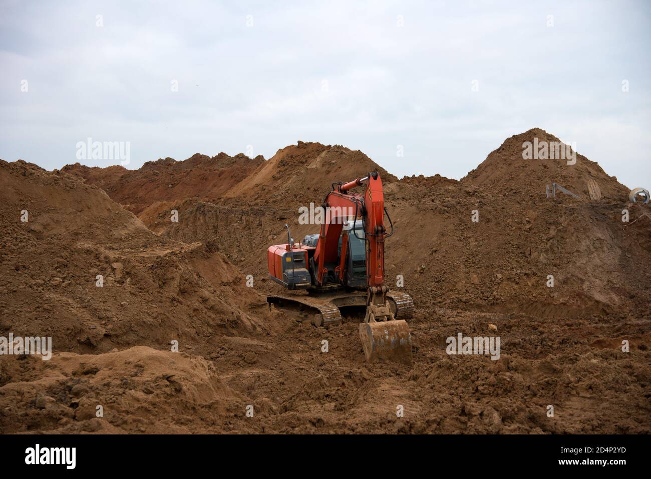 Track-type excavator during earthmoving at construction site. Backhoe ...