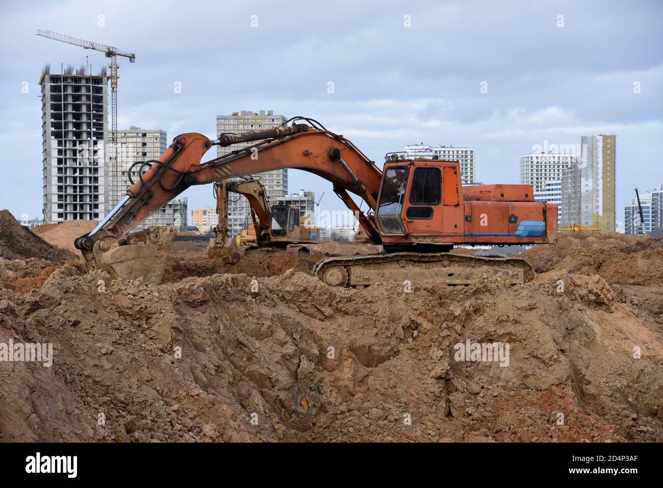 Group of the excavators for dig ground trenching at a construction site ...